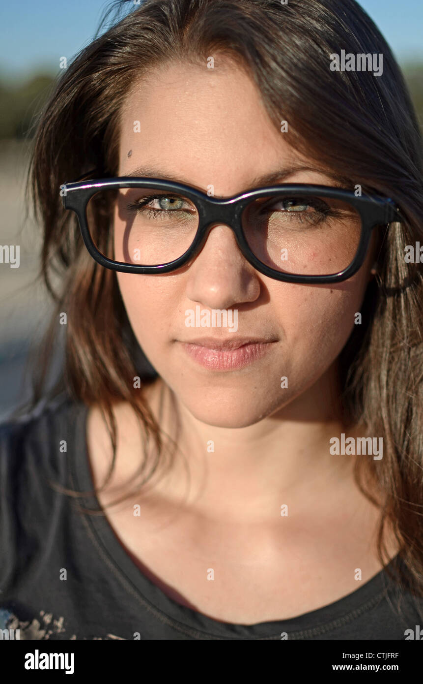 Cute young woman wearing black-rimmed glasses Stock Photo - Alamy
