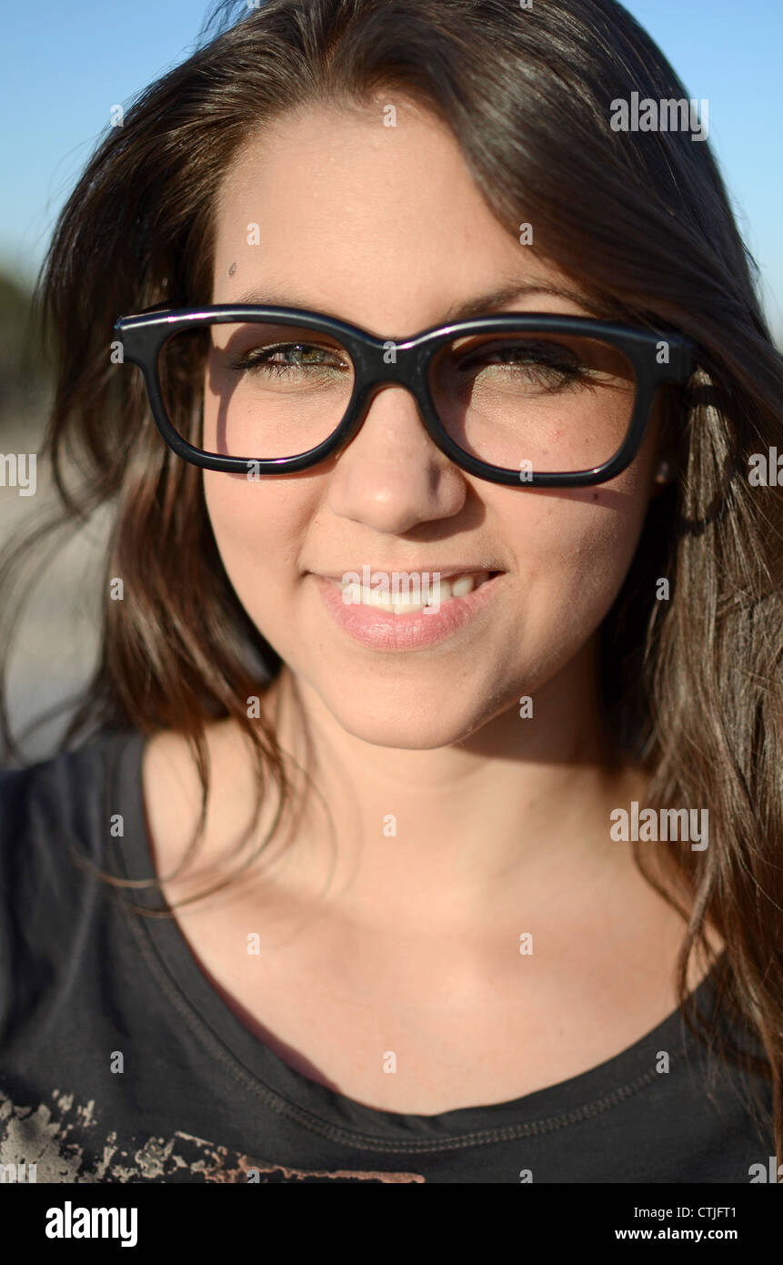 Cute young woman wearing black-rimmed glasses Stock Photo - Alamy