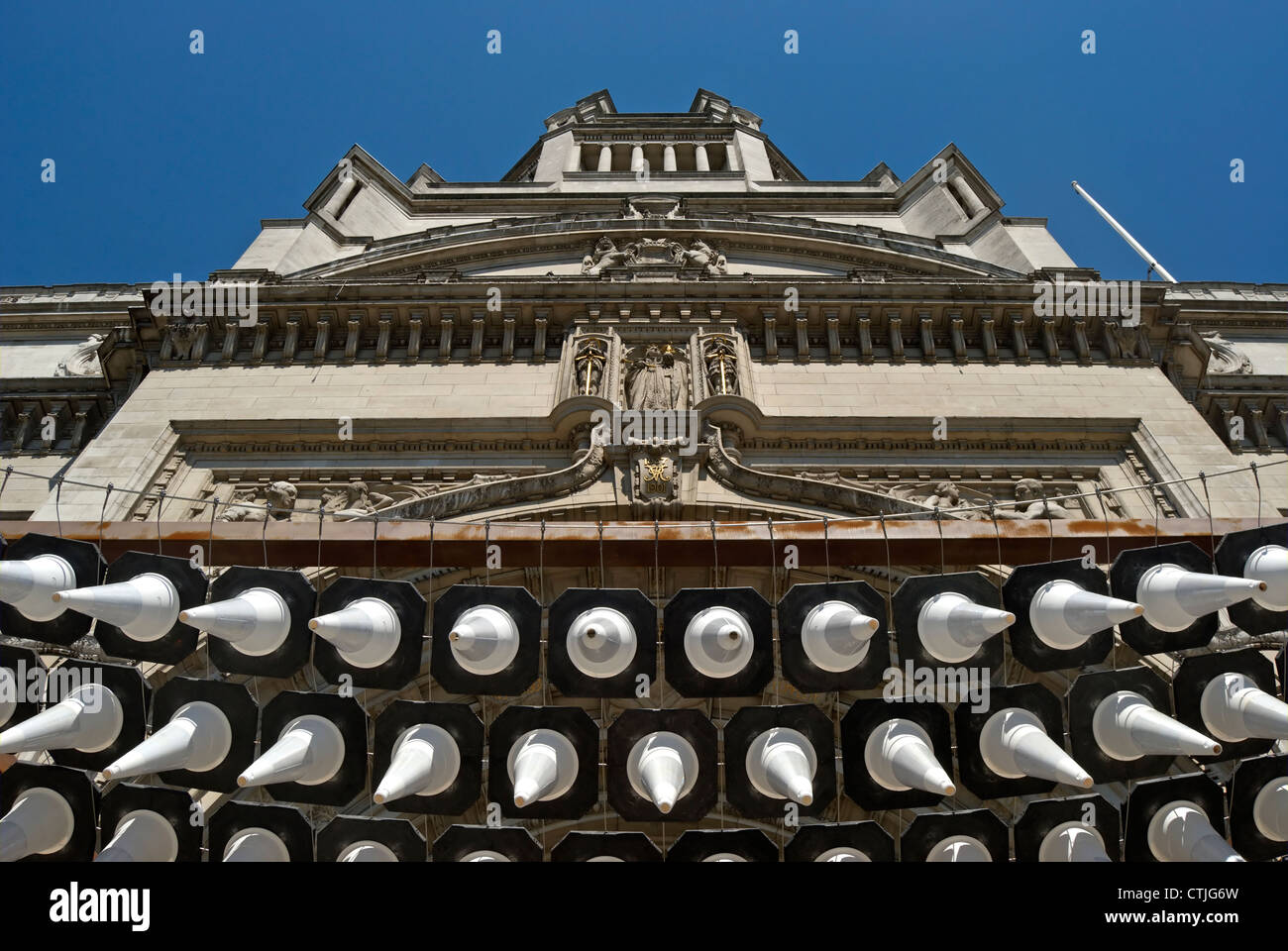 hanging sculpture composed of white traffic ones above the entrance to ...