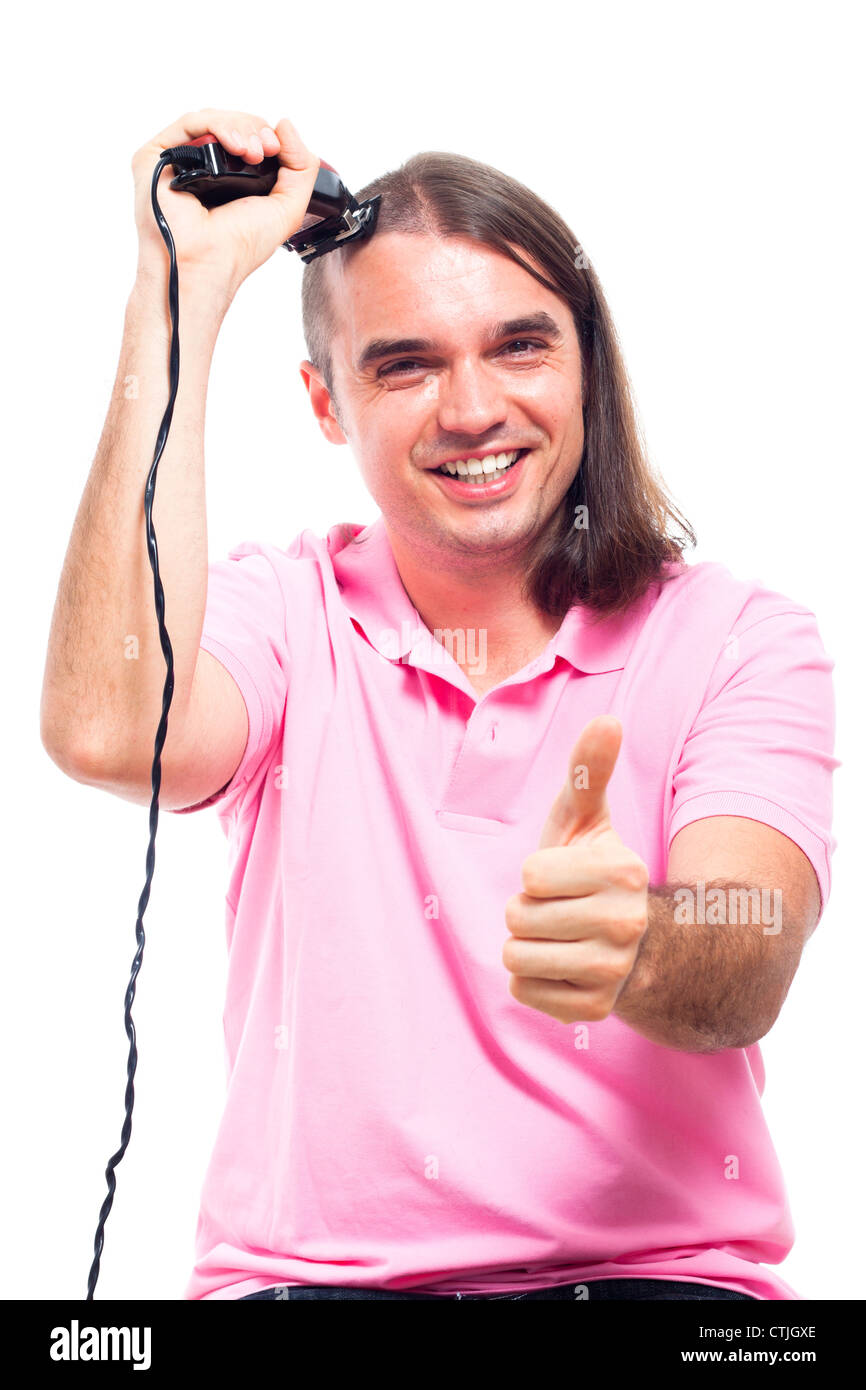 Happy young man shaving his head with hair trimmer, isolated on white ...