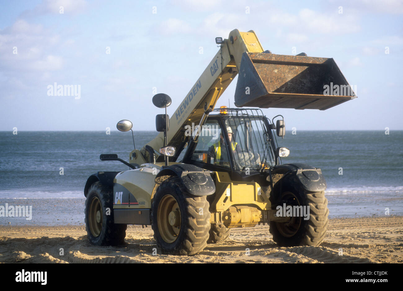 Caterpillar-TH330B Telehandler Construction vehicle shoring up sea ...