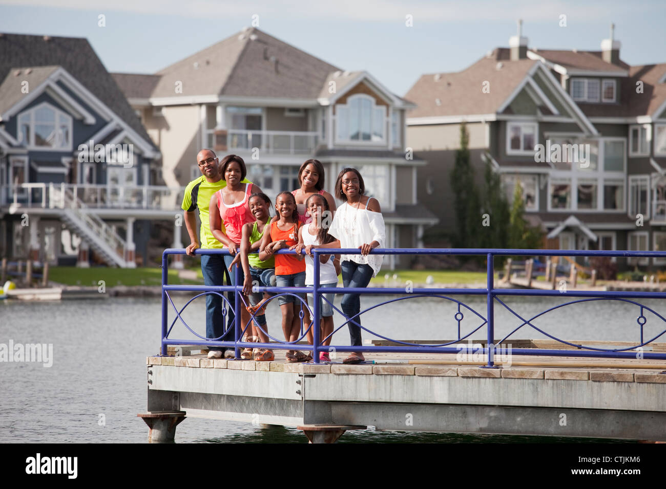 Family On A Pier In A Residential Lake Community; Edmonton, Alberta ...
