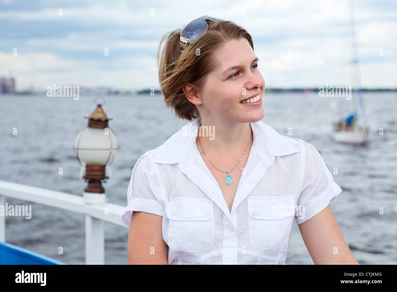 Attractive Caucasian Woman With Sunglasses In White Shirt Standing On