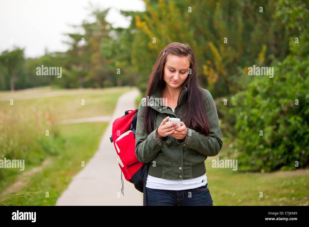 Checking messages while walking hi-res stock photography and images - Alamy