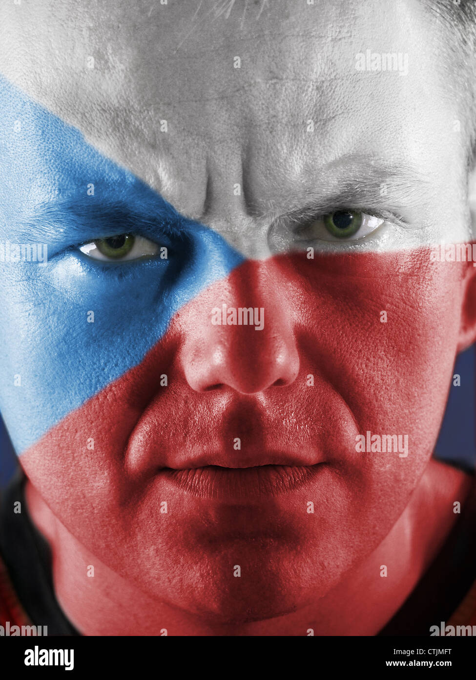 Closeup of young Czech supporter face painted with national flag colors ...