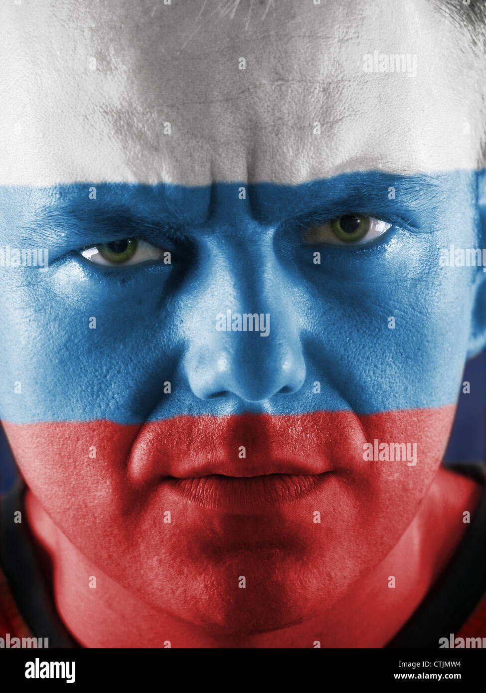 Closeup of young Russian supporter face painted with national flag ...