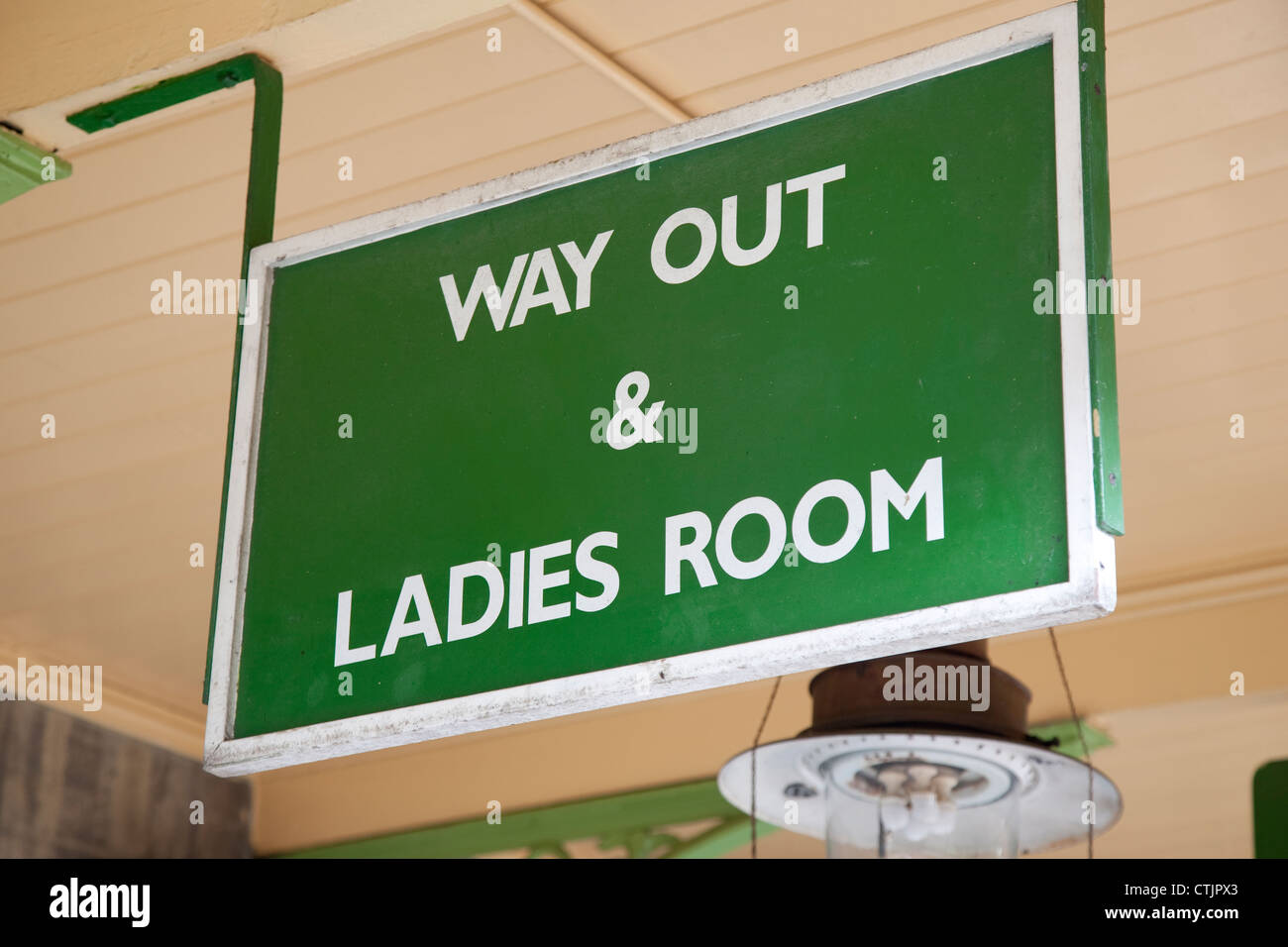 Green Way Out and Ladies Toilet Sign Stock Photo - Alamy