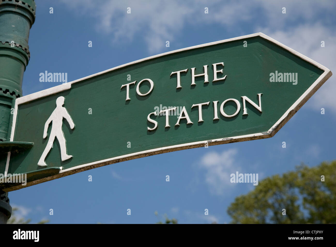 Green Station Sign against Blue Sky Background Stock Photo - Alamy