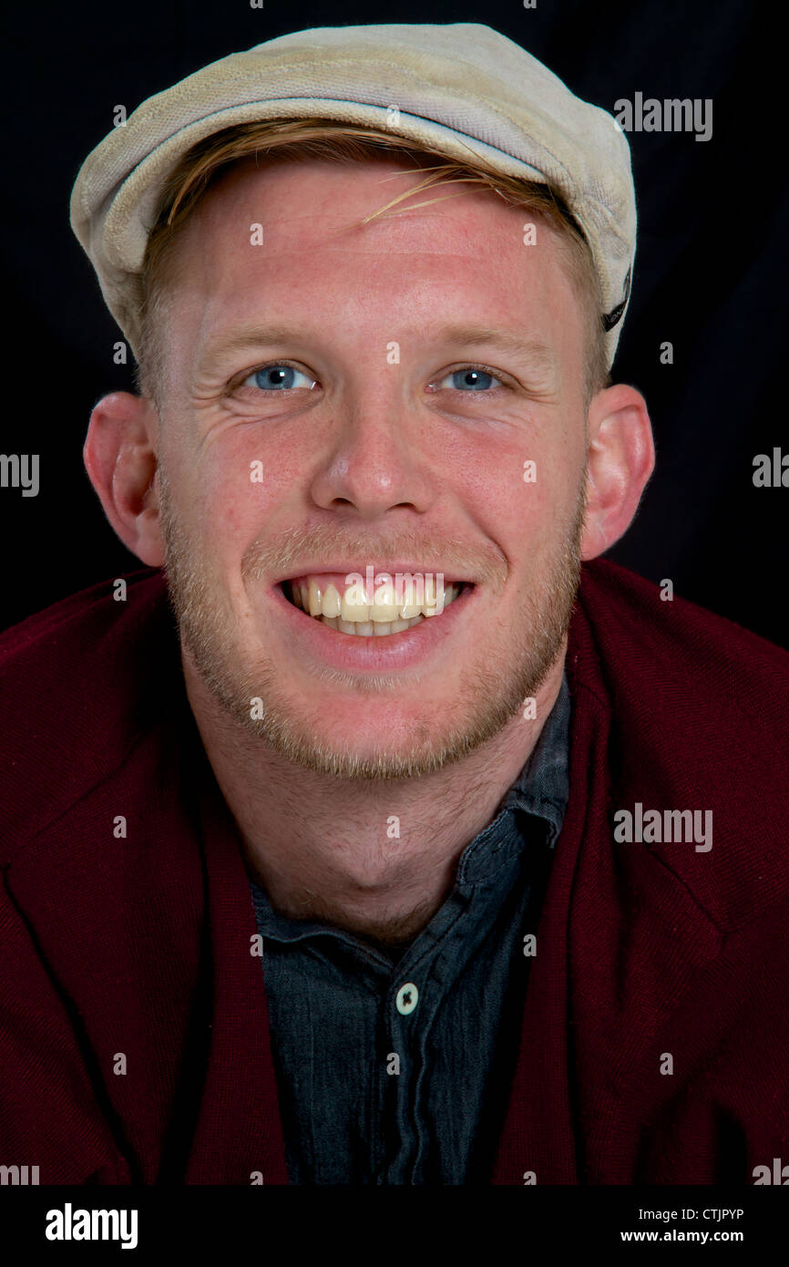 Portrait of a young man with cap smiling Stock Photo - Alamy
