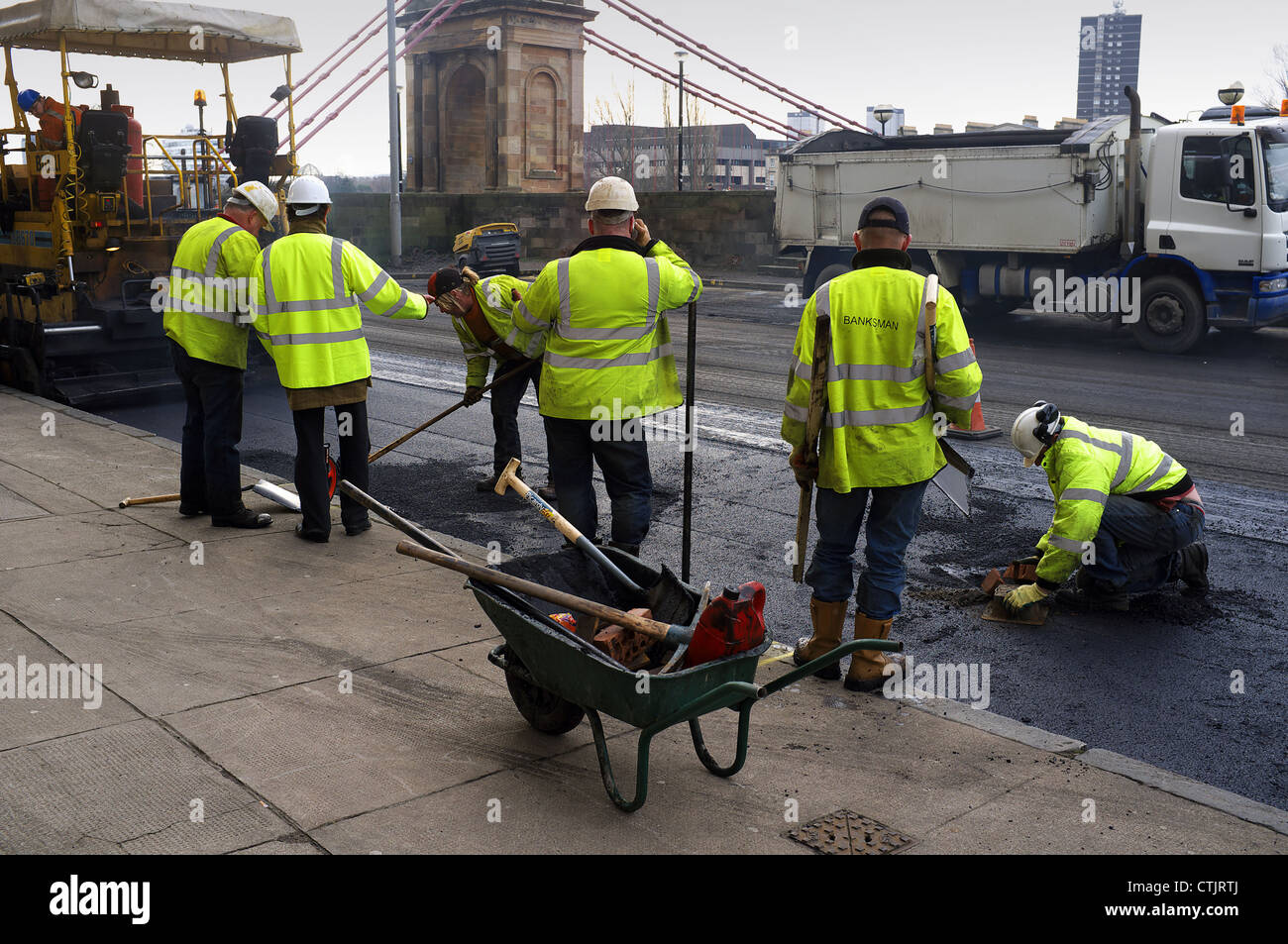 Workers repairing the road surface with tarmac, Glasgow, Scotland,UK ...