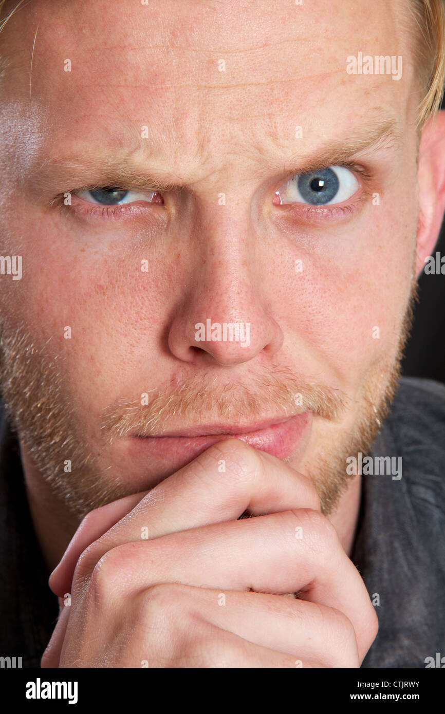 Young man suspicious Stock Photo - Alamy
