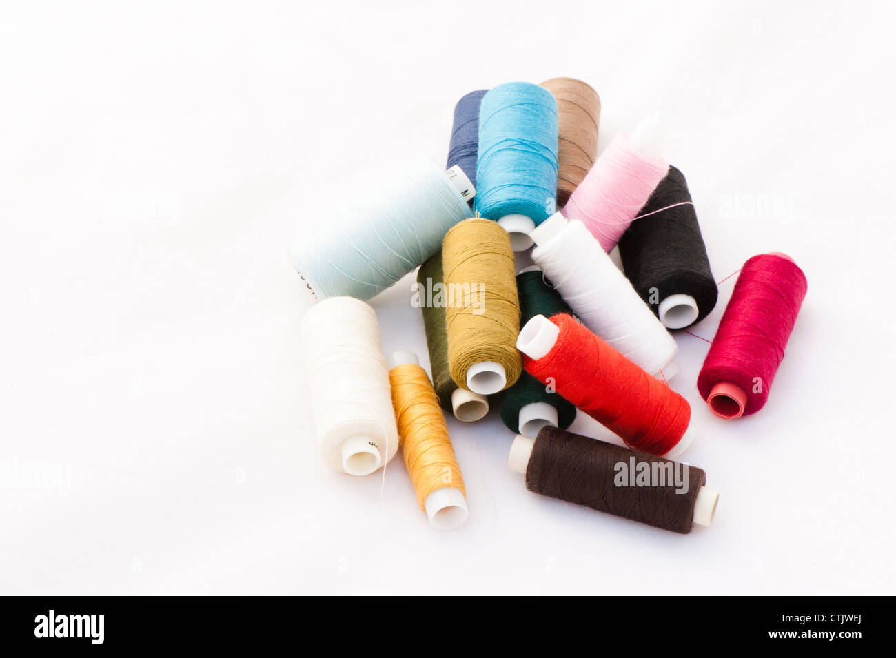A pile of multi-coloured sewing threads Stock Photo - Alamy