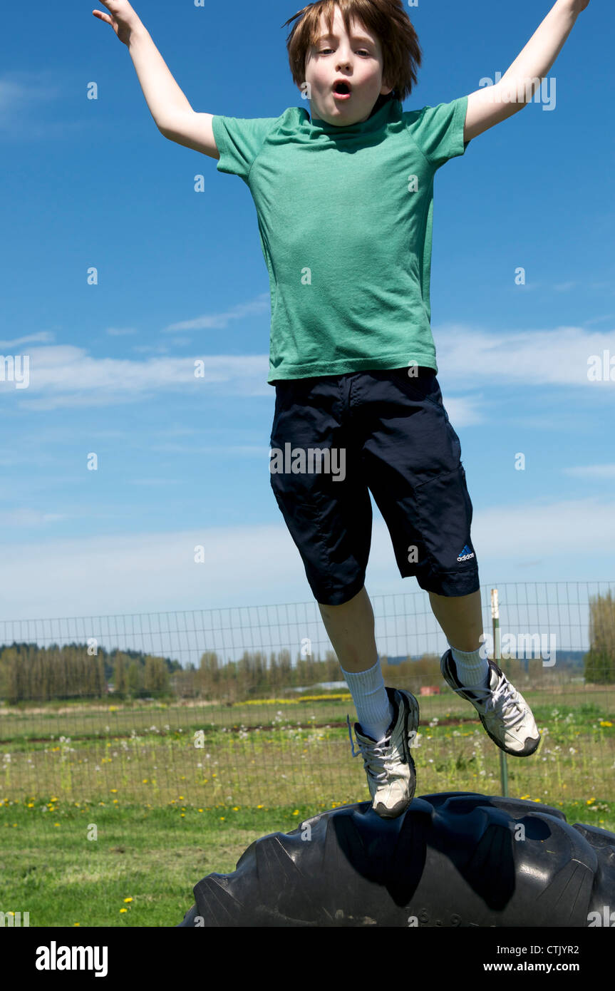 Boy leaps in air Stock Photo - Alamy