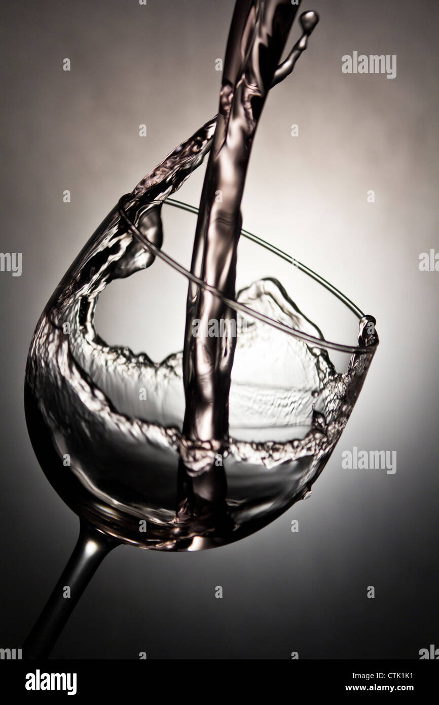 Liquid poring into wine glass Stock Photo - Alamy