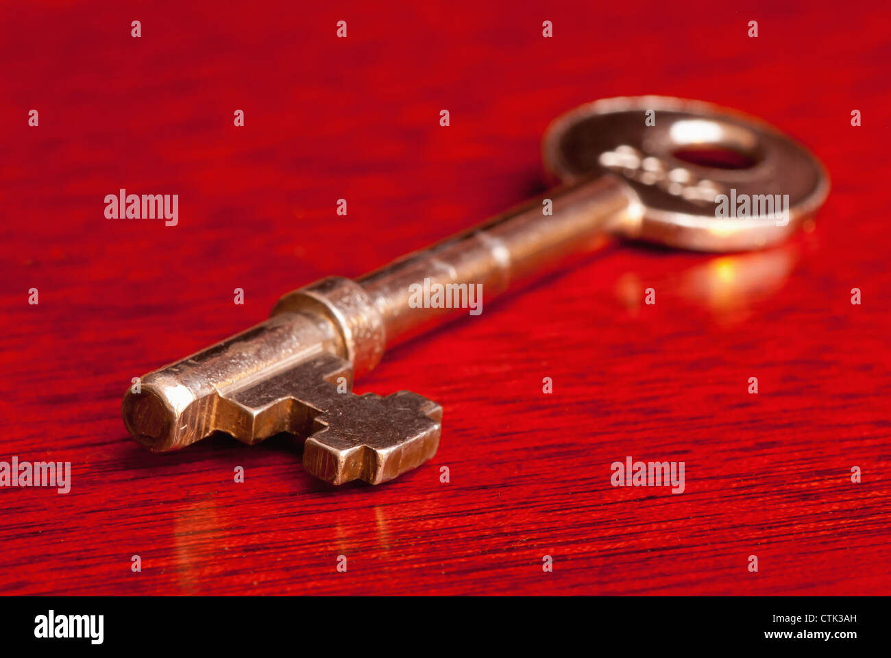 A Gold Key Sitting On A Red Table Stock Photo - Alamy