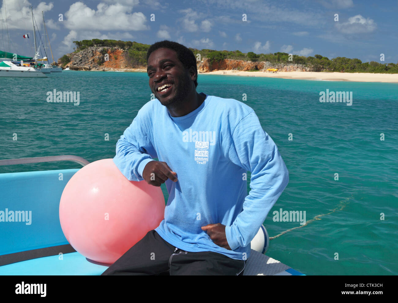 Captain relaxes while tour boat on day trip from St. Maarten is ...