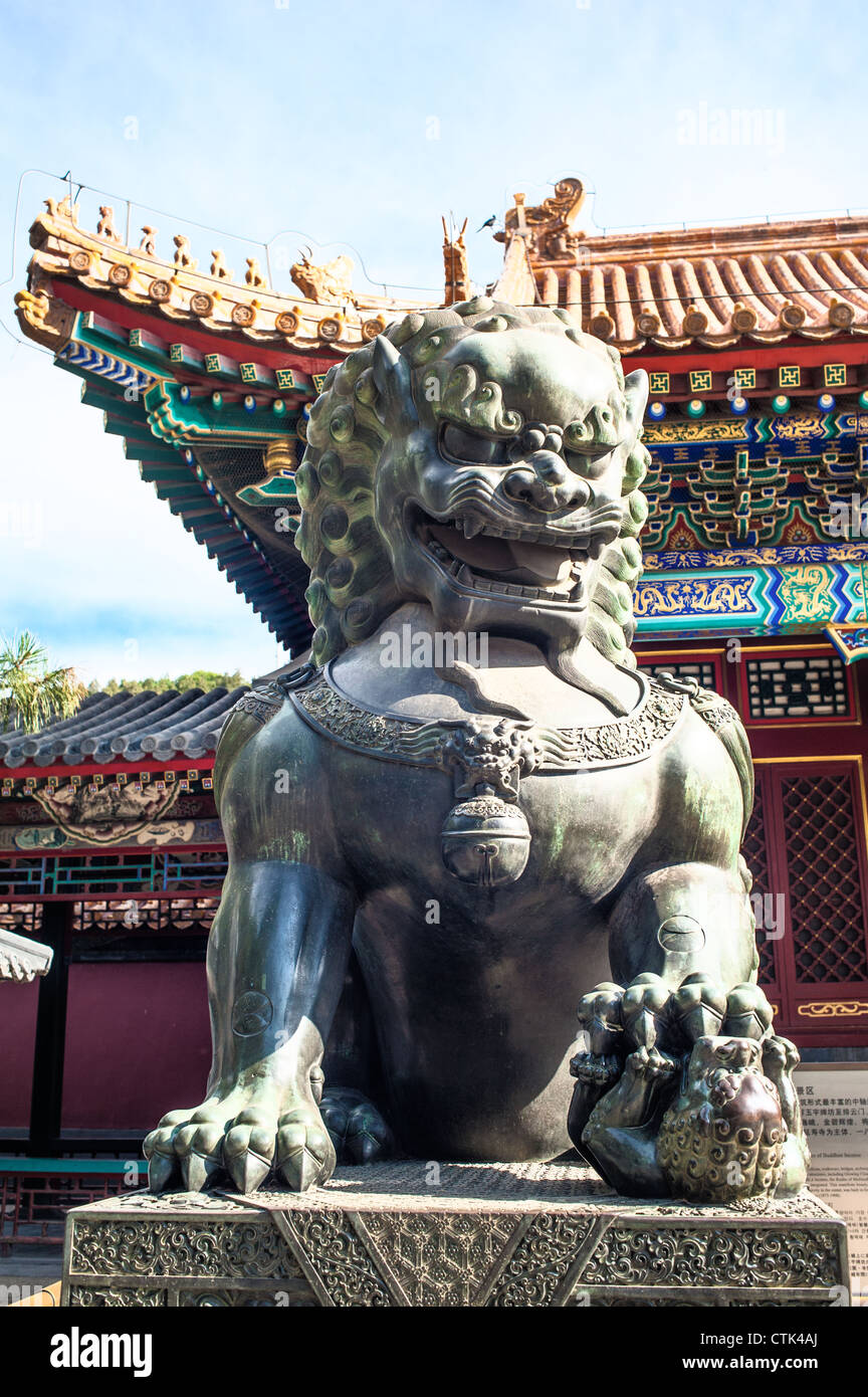 A copper lion standing in front of the ancient building in Summer ...