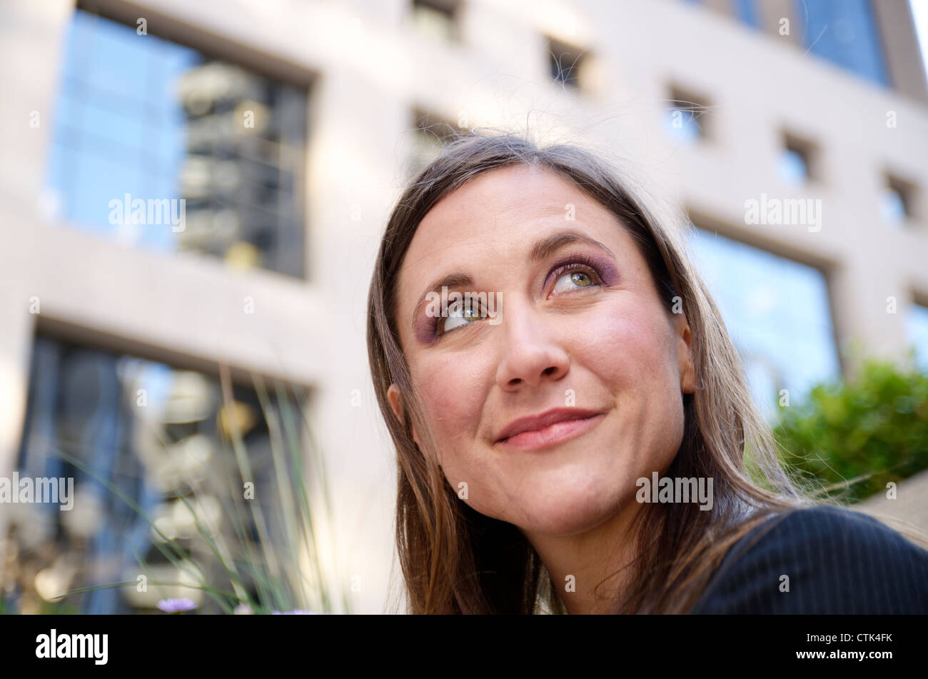 Woman looking up left smile hi-res stock photography and images - Alamy