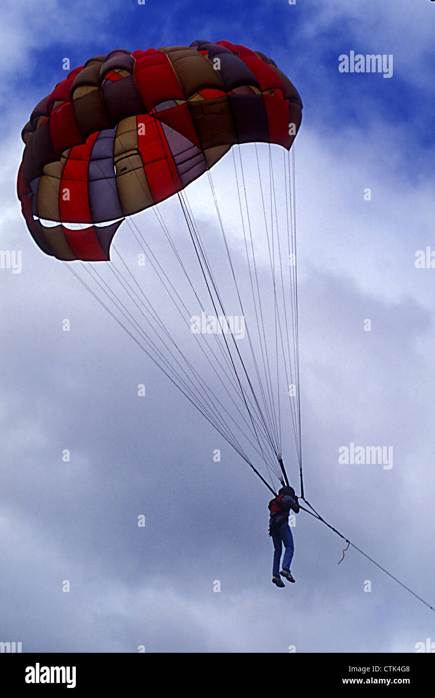 A person wngaged in daring act of sports of parasailing Stock Photo - Alamy