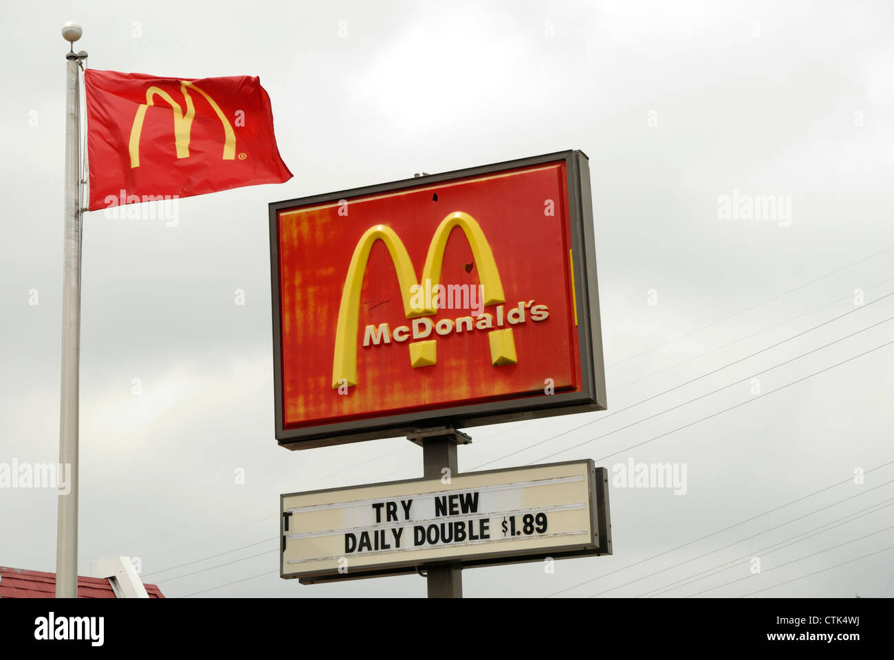 An older, worn McDonald's sign and flag in St. Louis County, MO Stock ...