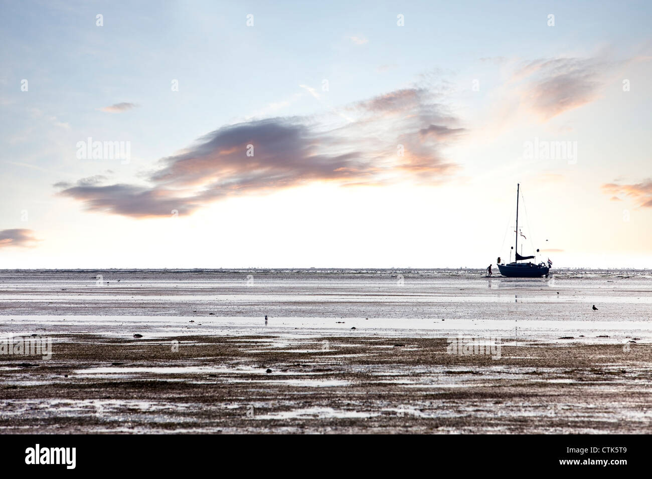 family stranded with sailboat at low tide Stock Photo - Alamy