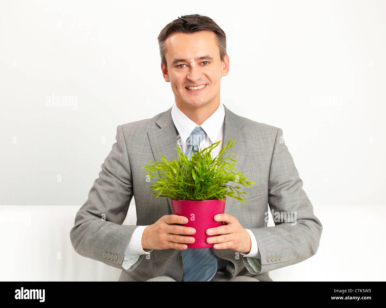 Smiling businessman being glad about how fast his new business grows ...