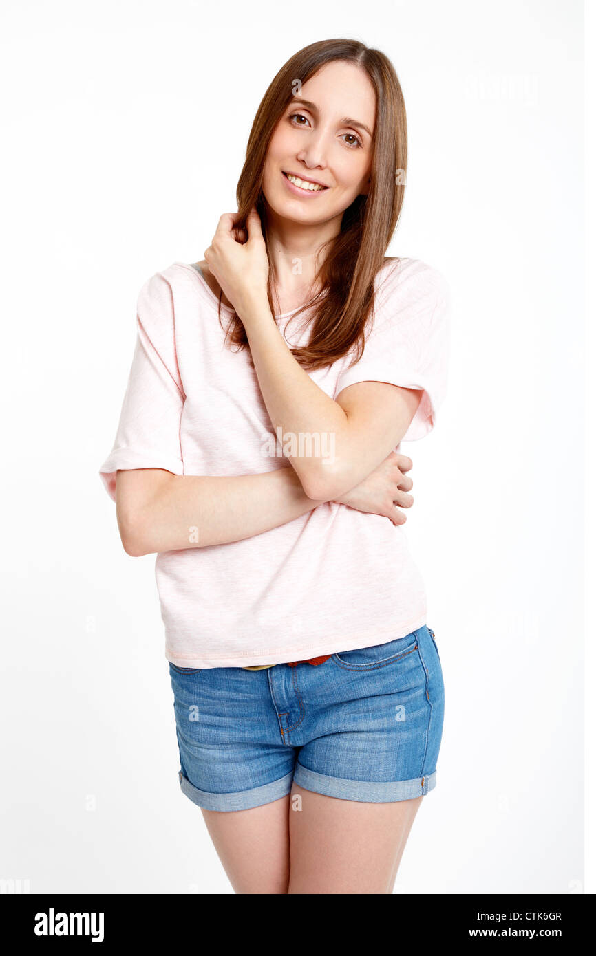 Young girl smiling touching her hair Stock Photo - Alamy