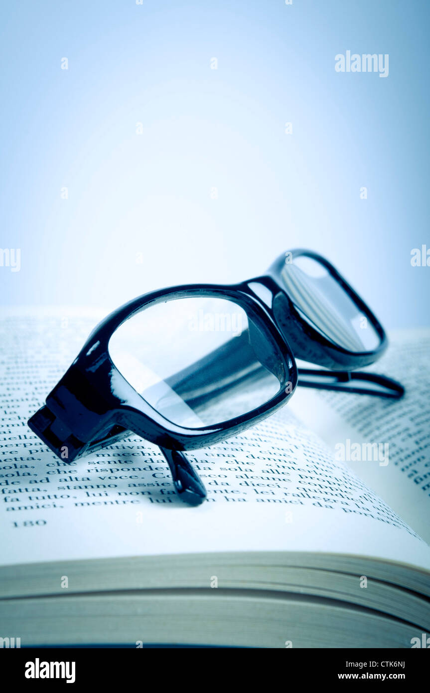 reading glasses on an open book Stock Photo - Alamy