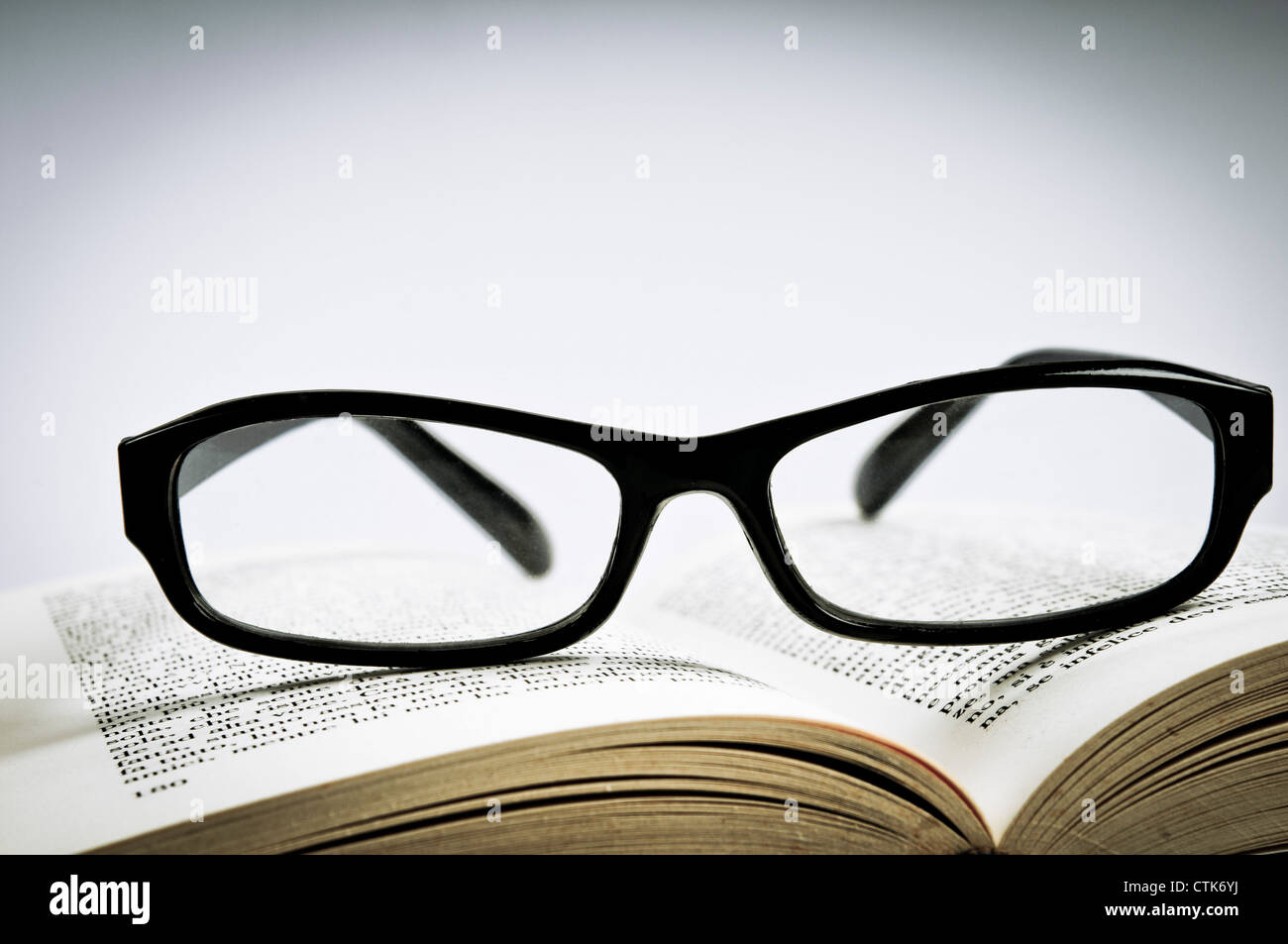 reading glasses on an open book Stock Photo - Alamy