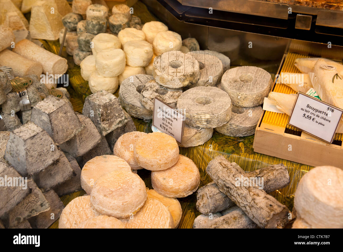 Various cheeses displayed in a fromagerie in Rue Cler on the Left Bank ...