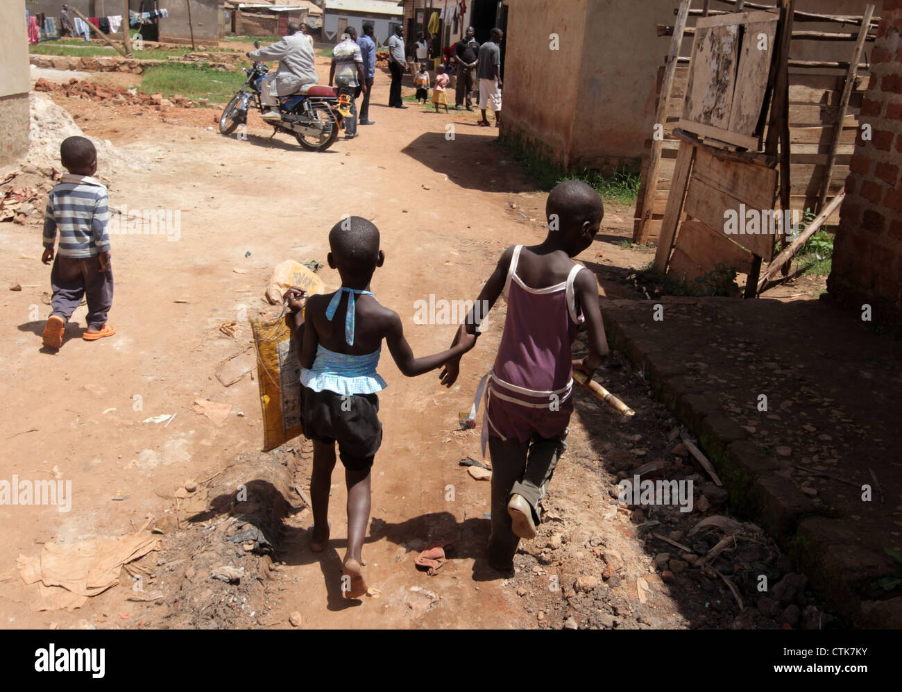 Young friends embrace as they walk through the Kosovo slum area of ...