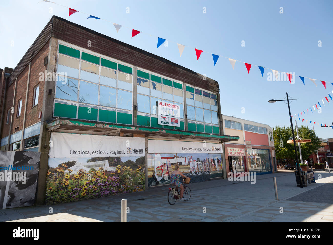empty shop unit with large poster display by local council to make the ...