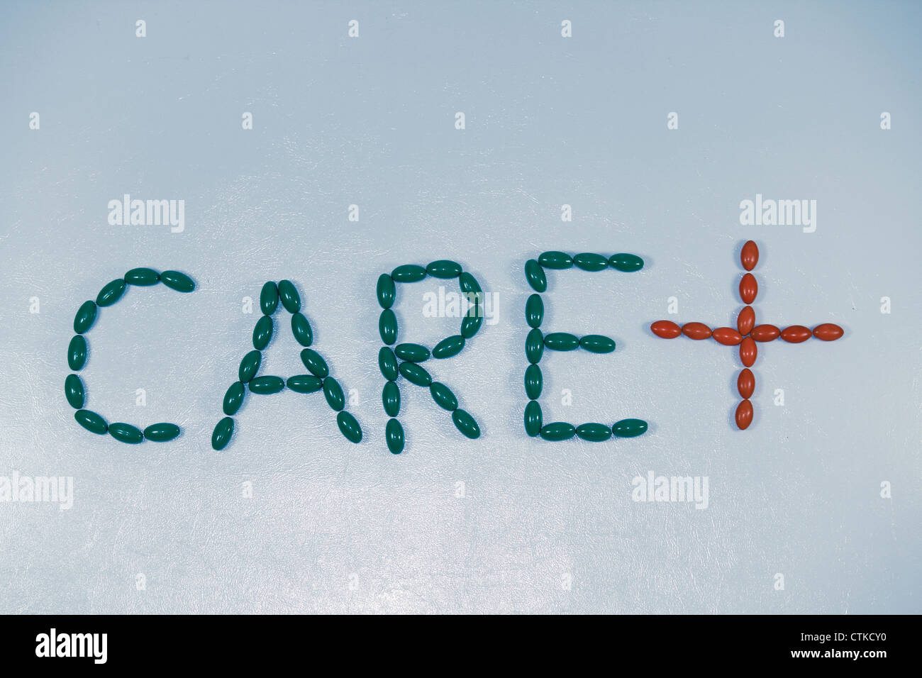 Care Word with cross symbol arranged with pills Stock Photo - Alamy