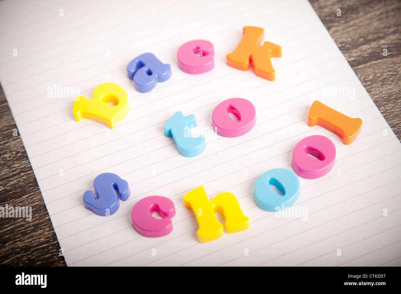 'Back To School' spelt out on lined paper, using fridge magnets Stock ...
