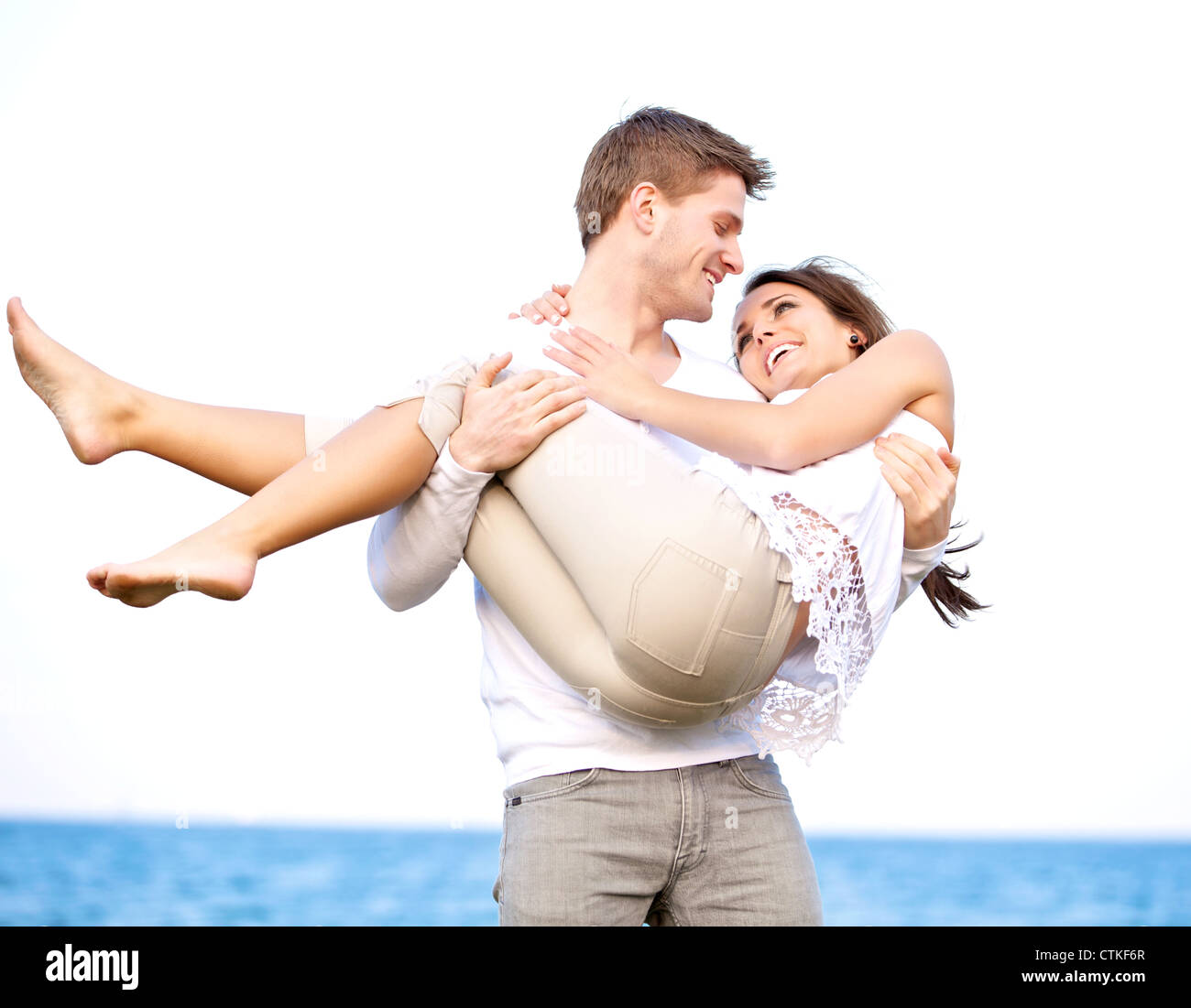 Portrait of a romantic guy looking affectionately at his girlfriend ...