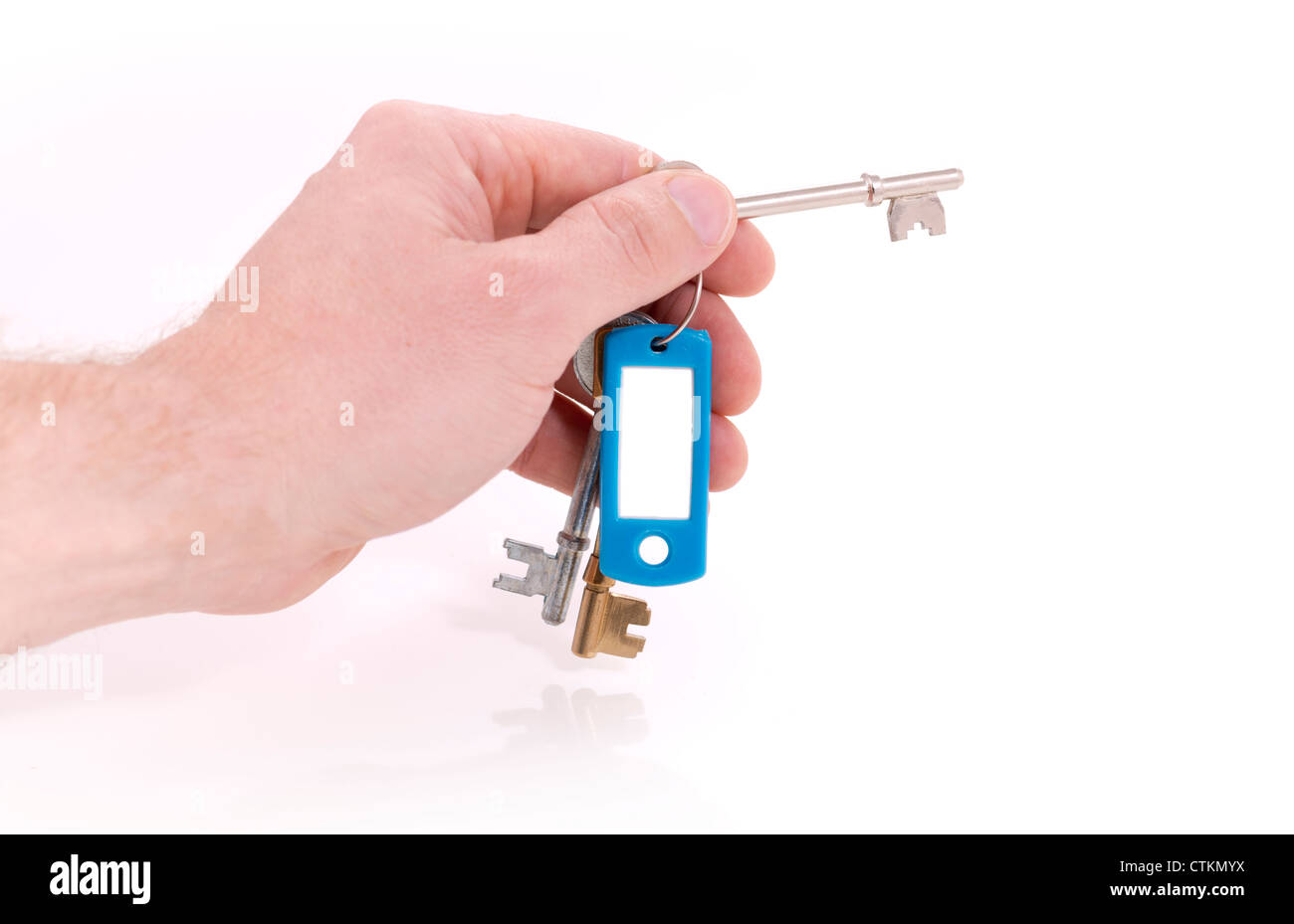 hand holding keys ready to unlock on white background Stock Photo - Alamy