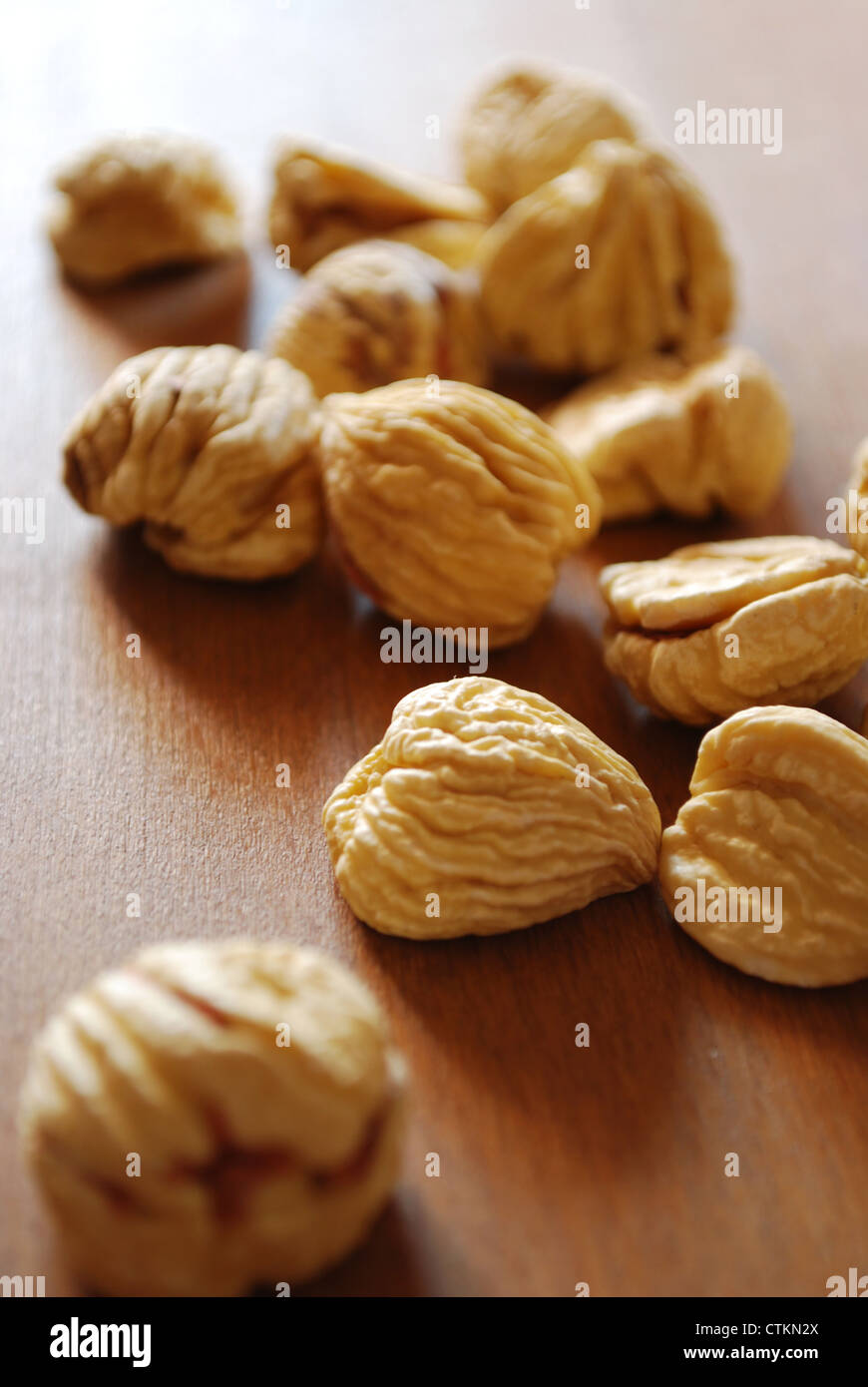 Dried chestnuts on natural wooden table background Stock Photo - Alamy