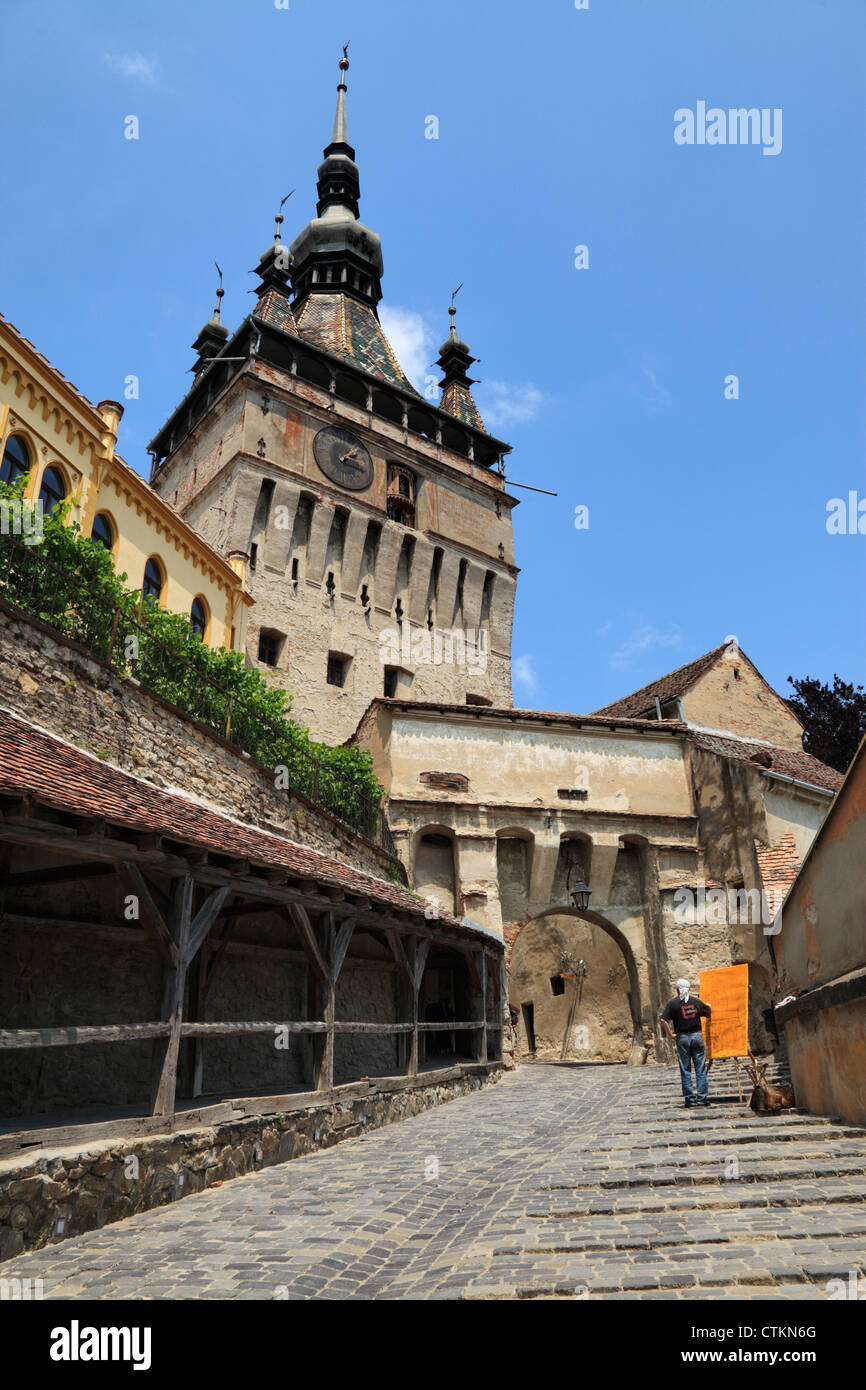 Artist painting on an easel beneath the Clock Tower in the medieval ...