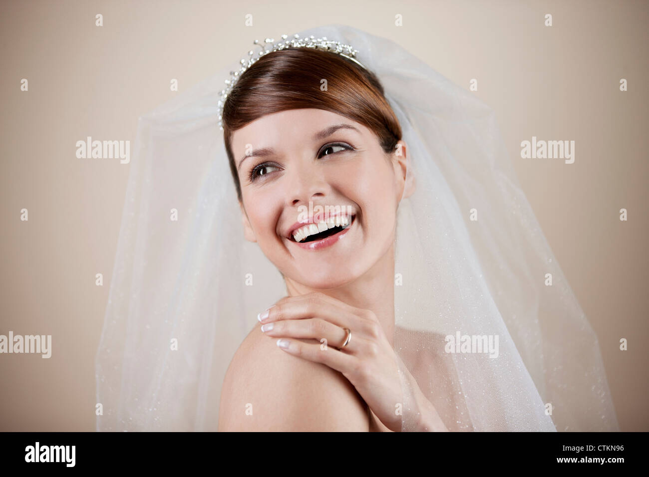 A young bride looking over her shoulder Stock Photo - Alamy