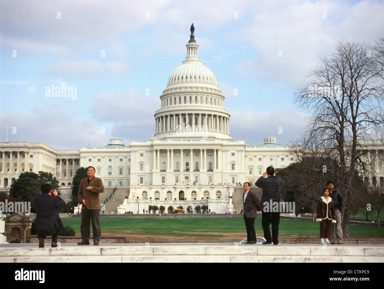 Tourists posing in front of the US capitol building, Washington DC ...