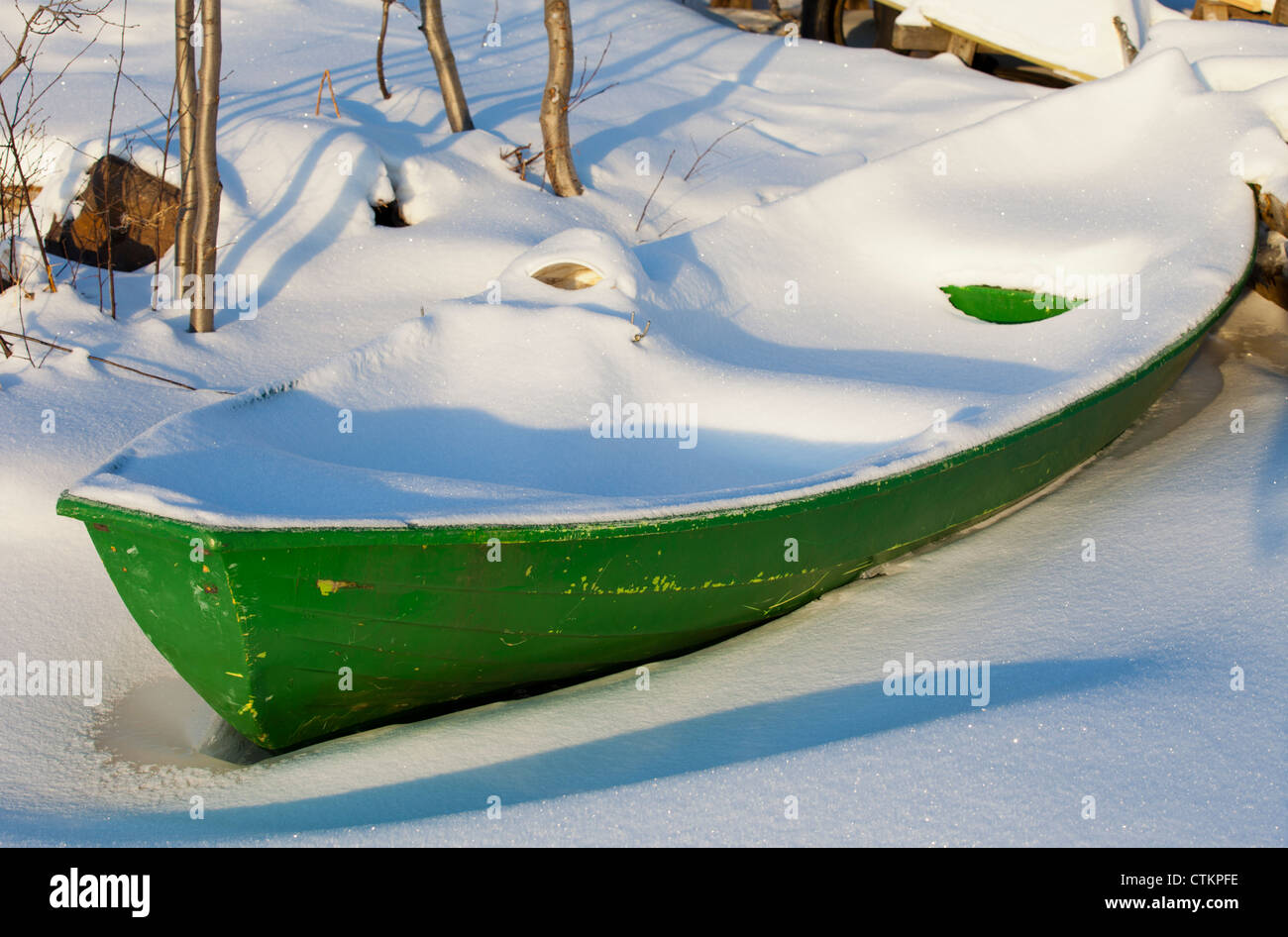Green rowboat / skiff full of snow , Finland Stock Photo - Alamy