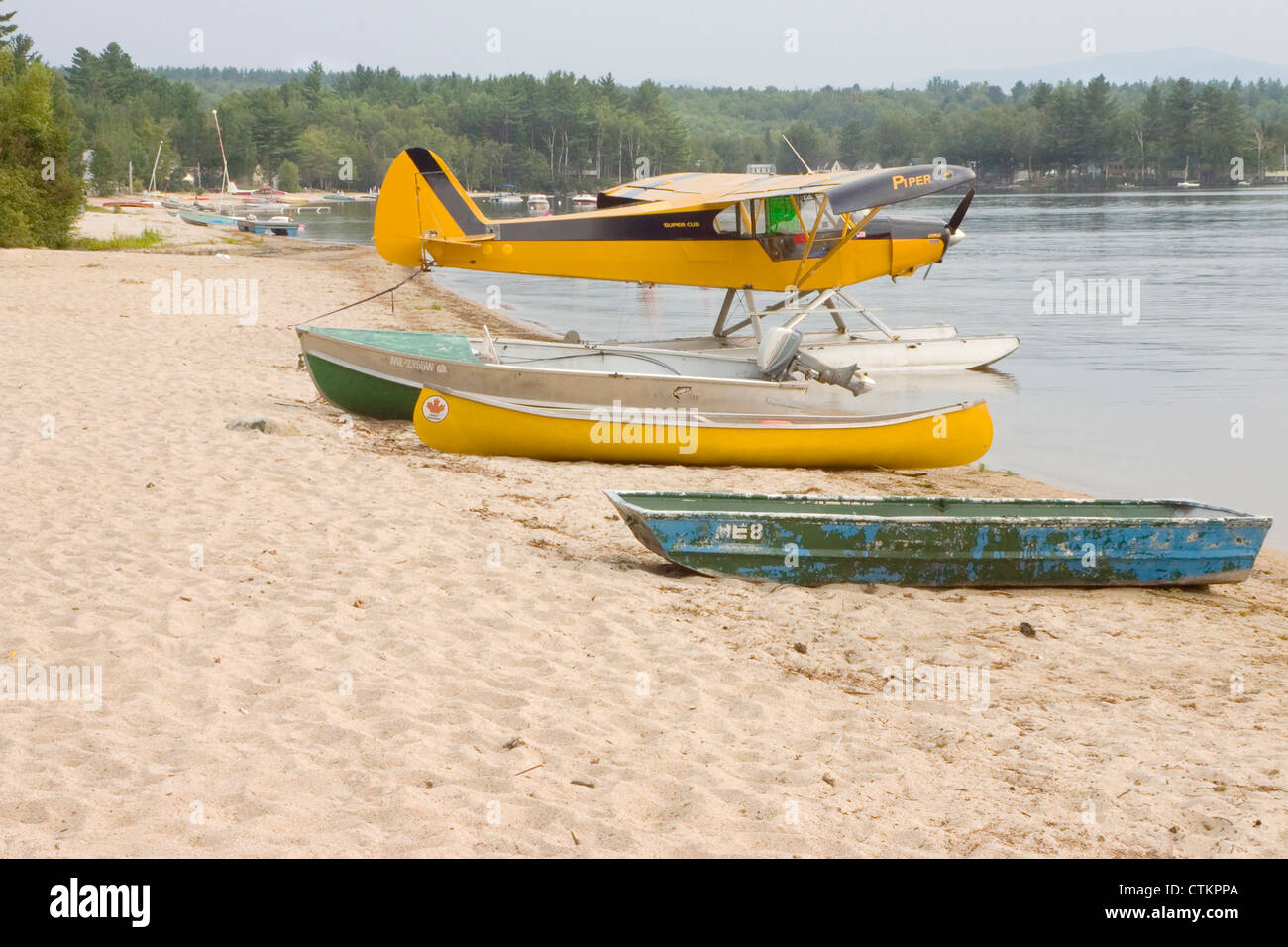 Yellow Piper Super Cub float plane at a pond in Maine Stock Photo - Alamy