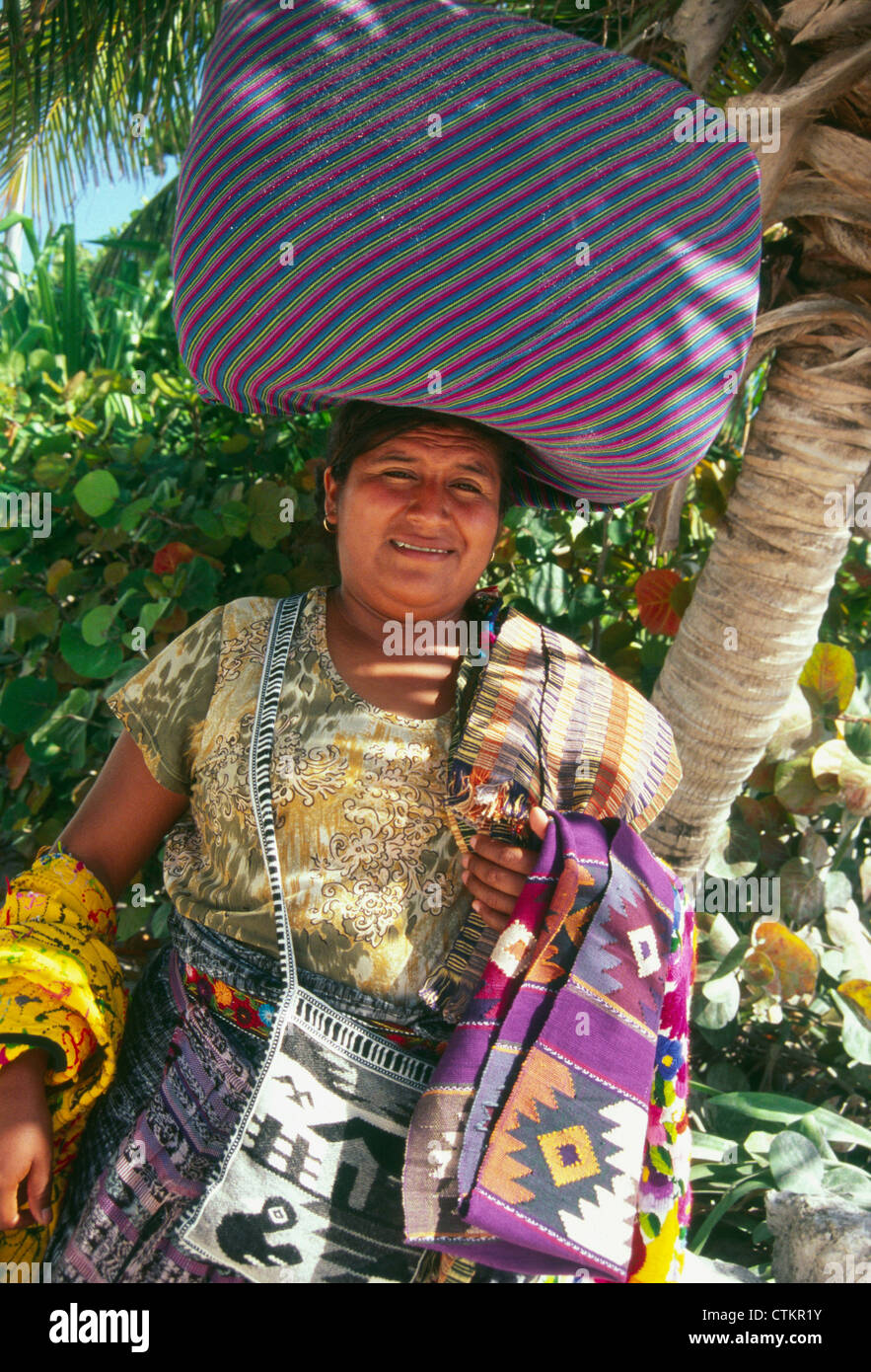 A woman selling local crafts on the beach in Belize Stock Photo - Alamy