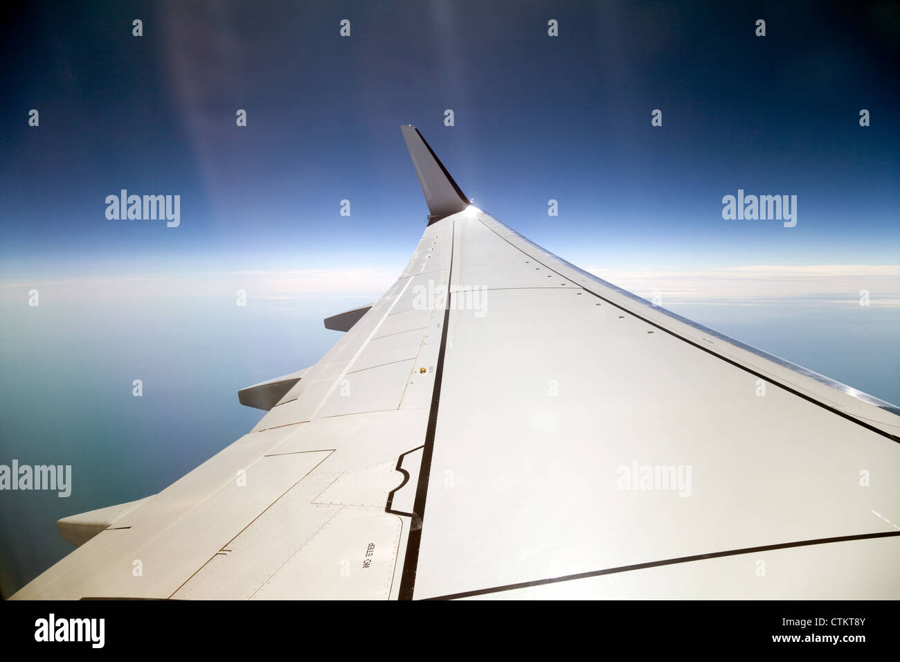Aircraft wing in flight through plane window Stock Photo - Alamy