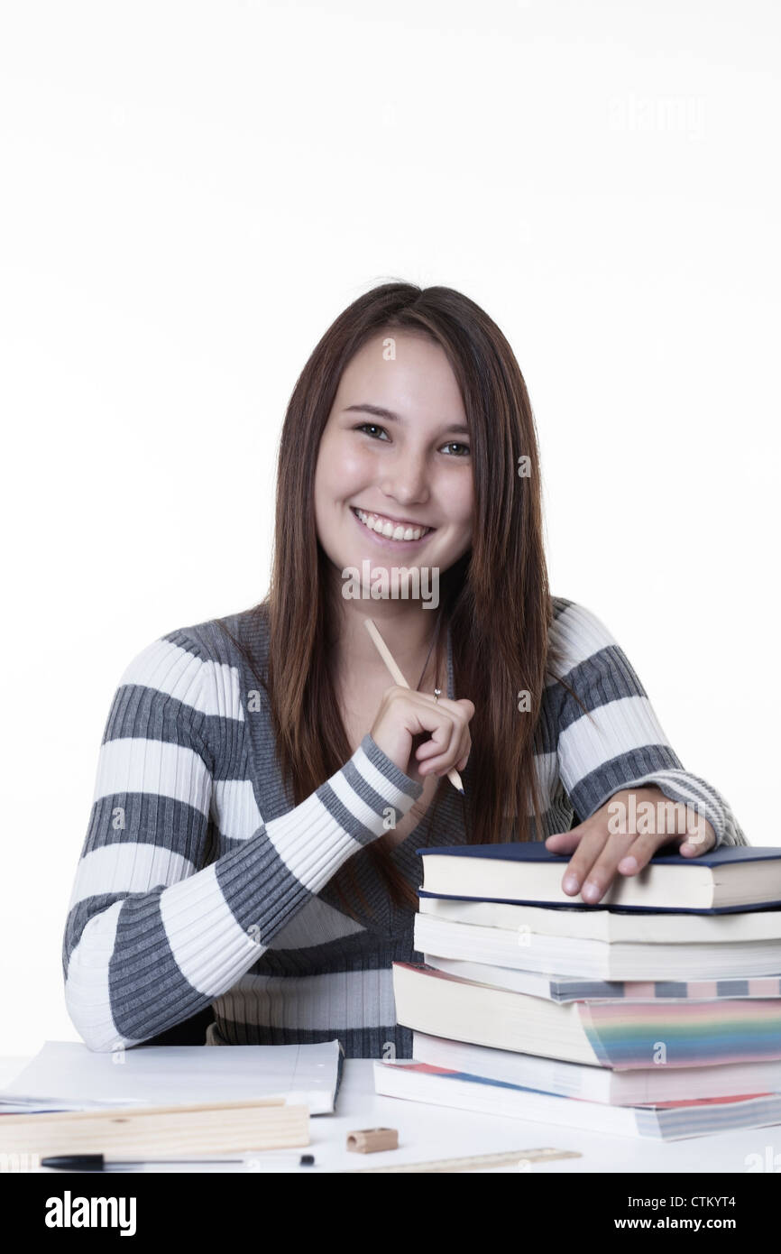 young woman working hard, looking at books and writing notes sitting at ...
