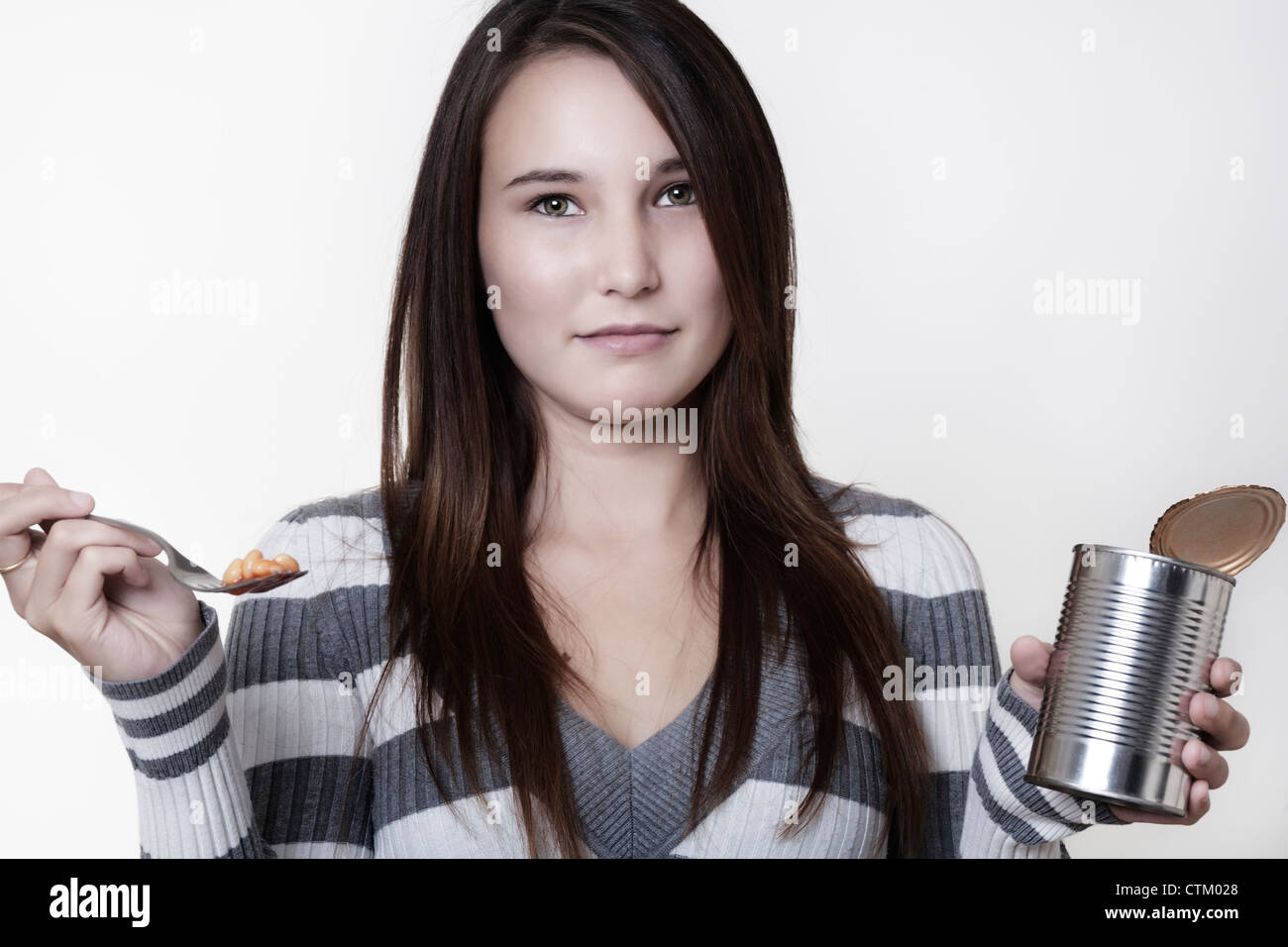 young woman eating cold bake beans from the tin Stock Photo - Alamy