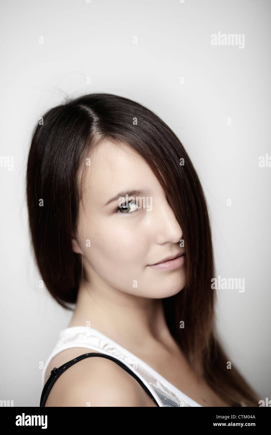 woman with long hair going down one side of face Stock Photo - Alamy