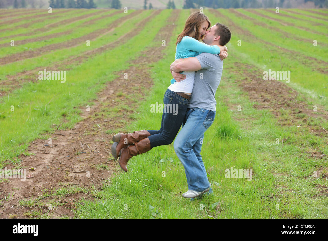 Young Man Spinning Young Woman Around In A Field; Troutdale, Oregon ...