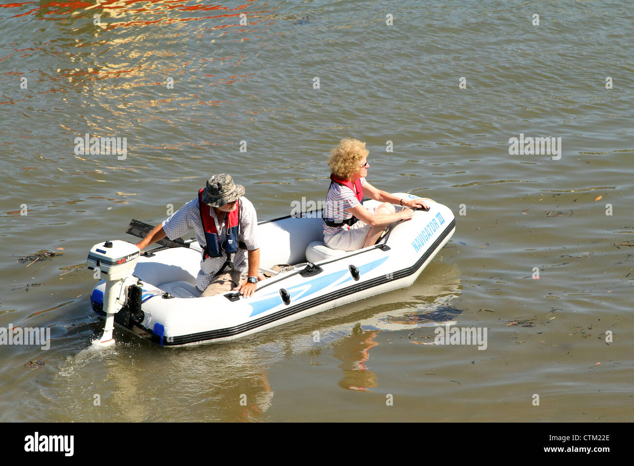 Mature couple in a small rubber boat Stock Photo - Alamy