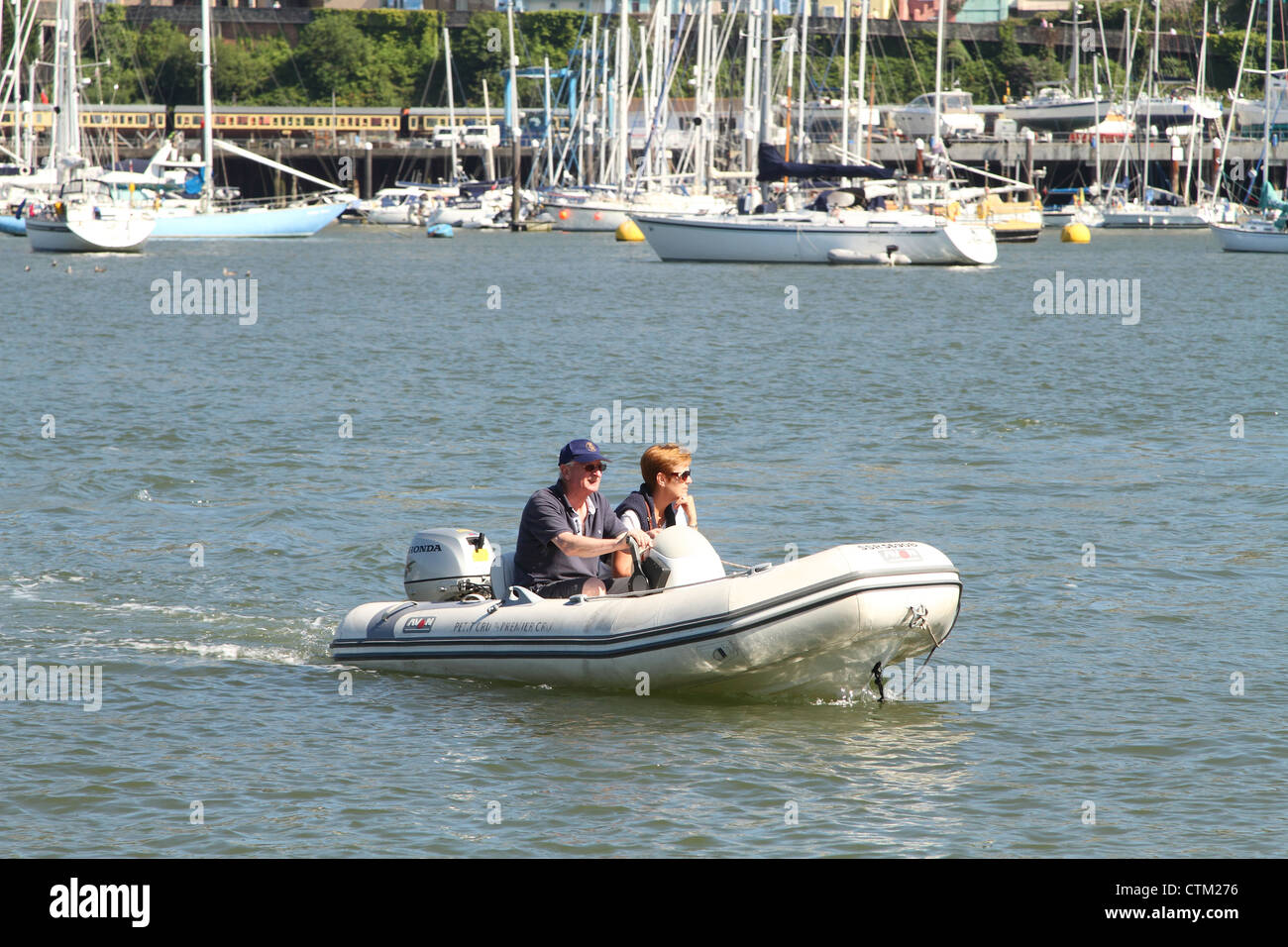 Mature couple in their speed boat tender Stock Photo - Alamy